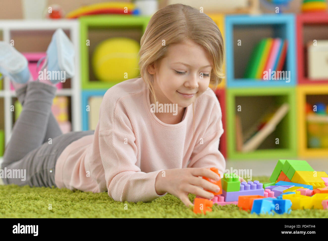 little girl with colorful plastic blocks Stock Photo - Alamy