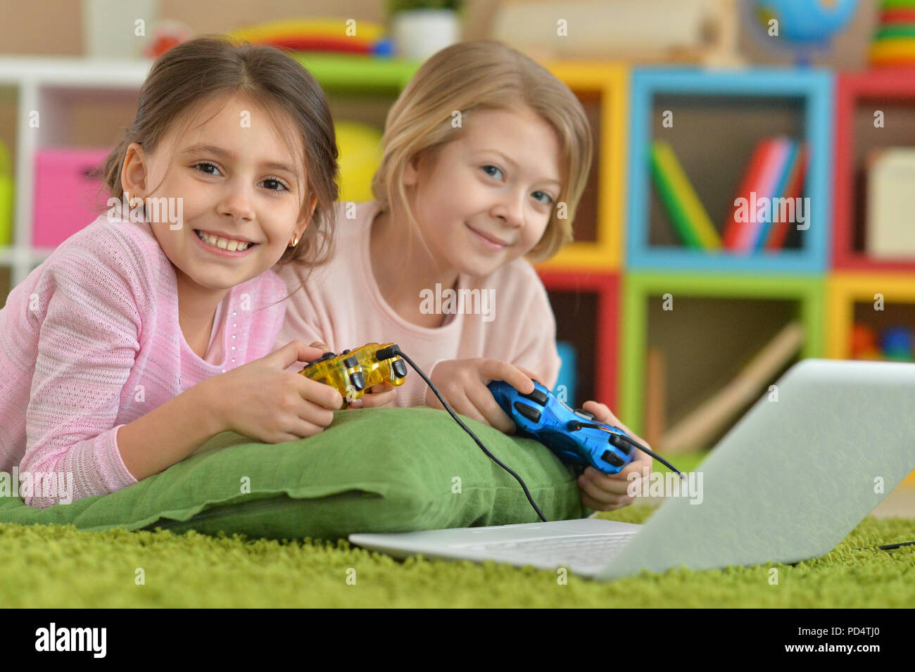 little girls playing computer game Stock Photo - Alamy