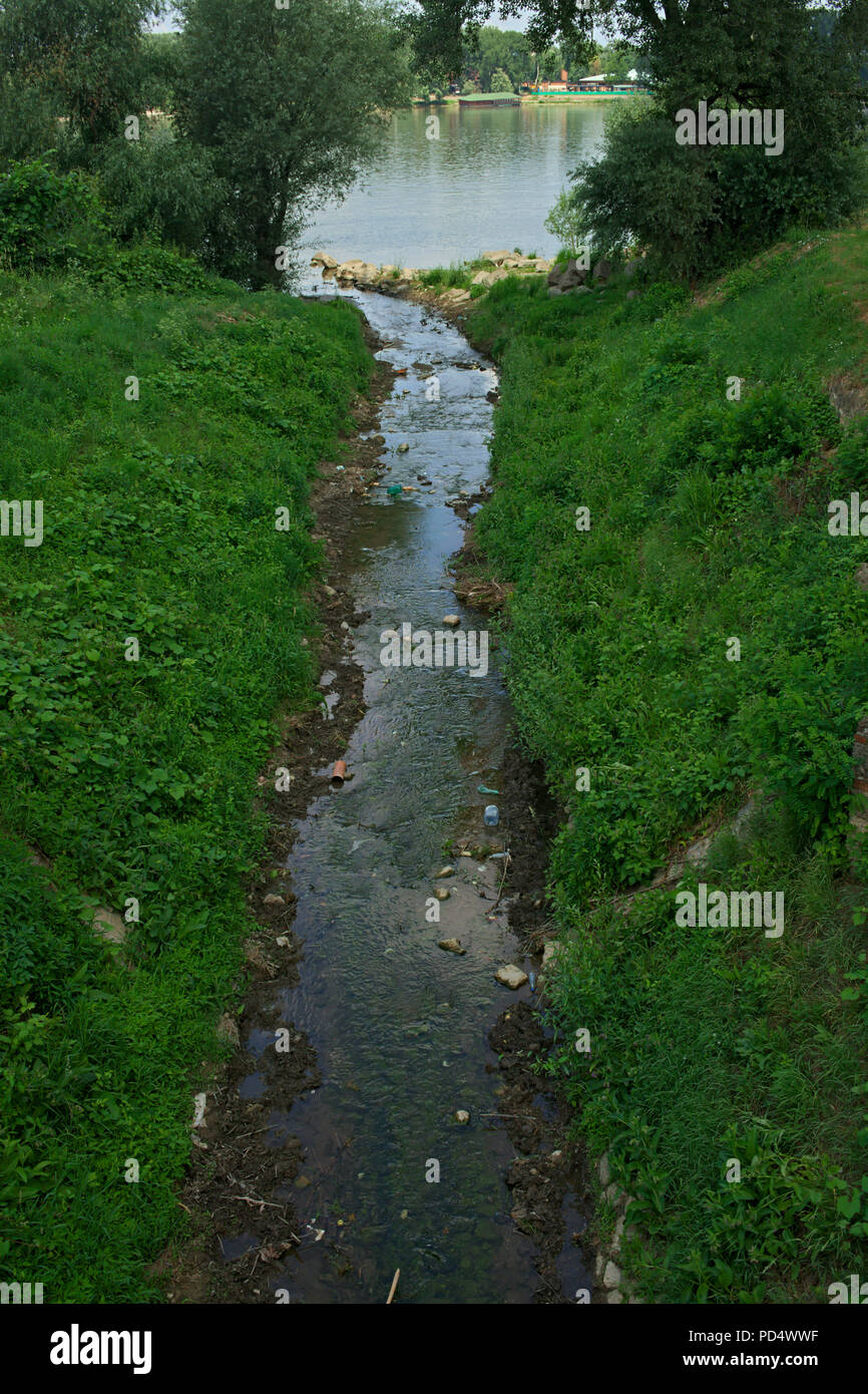 Small water stream flowing into big river Danube Stock Photo - Alamy