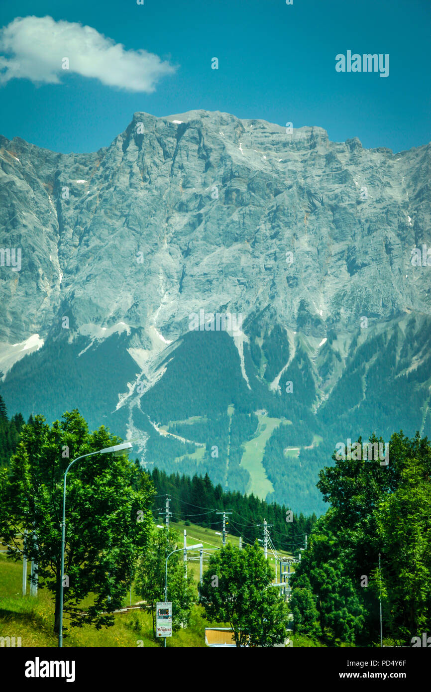 View of the Zugspitze mountains in Austrian alps in summer with holiday ...