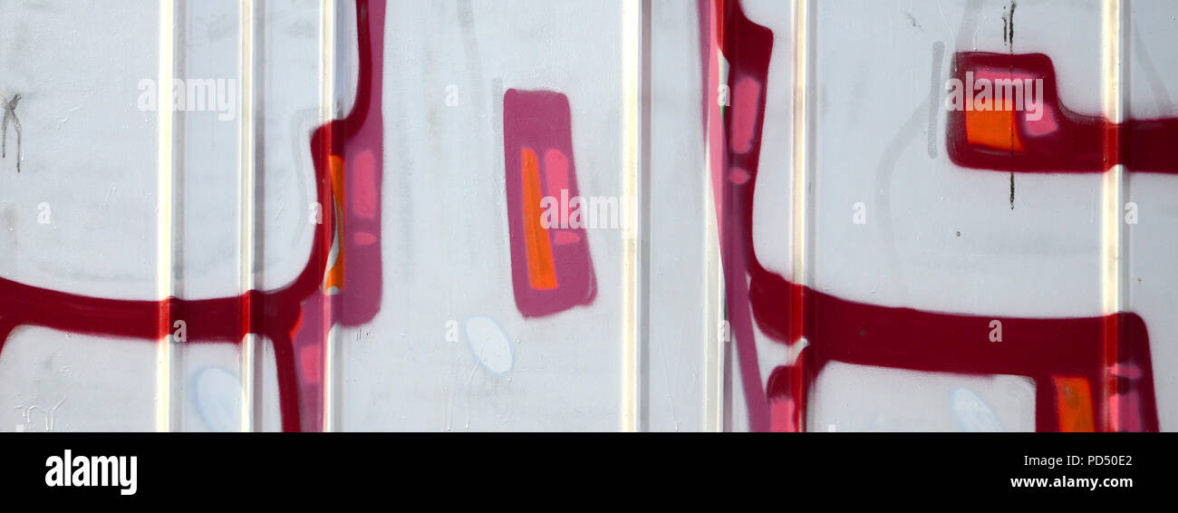 The old wall, painted in color graffiti drawing red aerosol paints ...