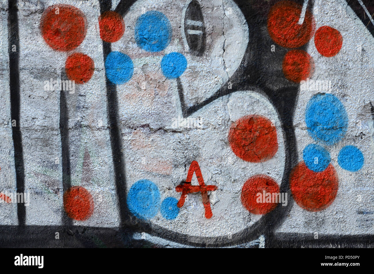 The old wall, painted in color graffiti drawing red aerosol paints ...
