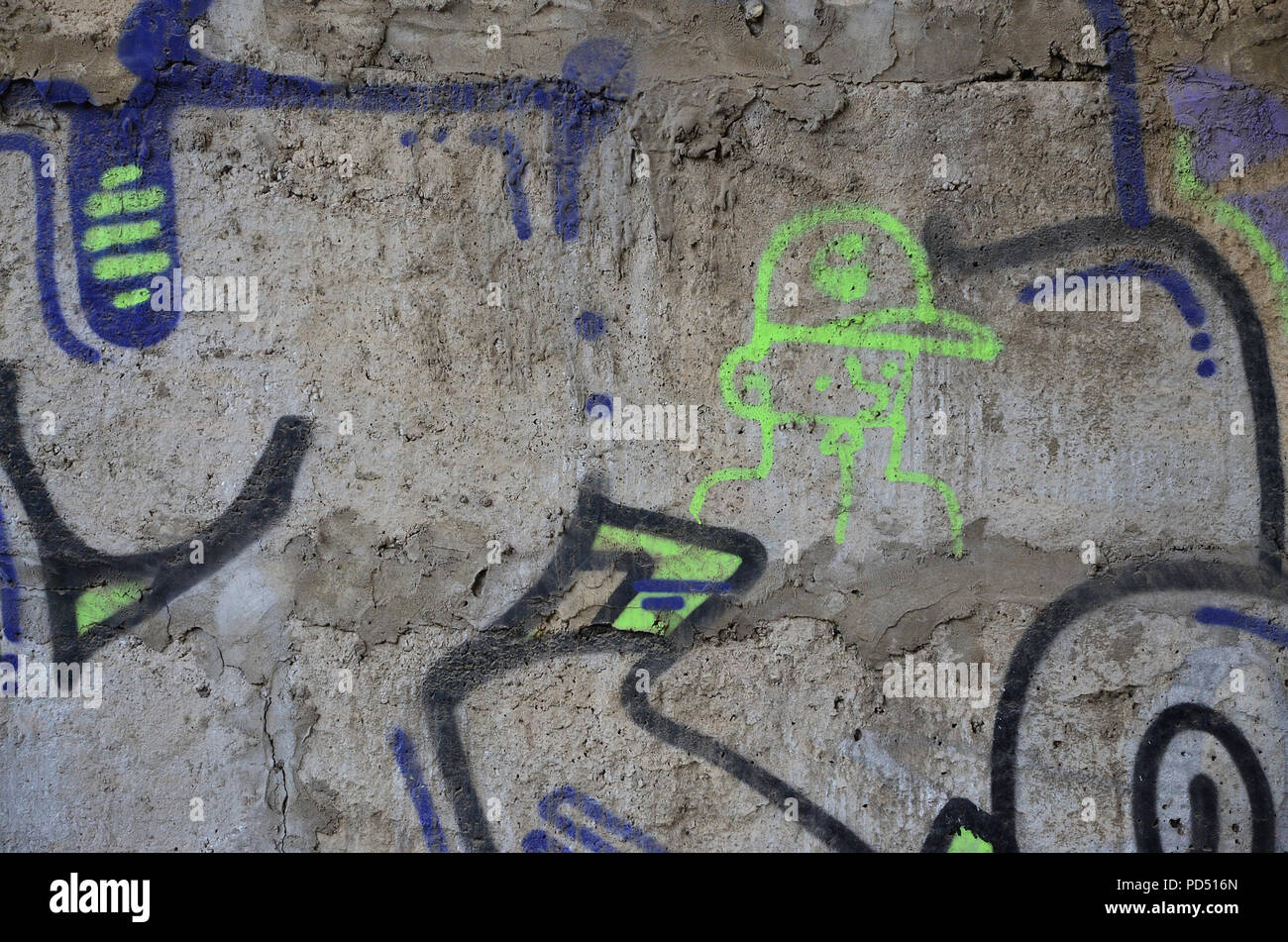 Detailed image of very old and aged color graffiti drawing on the wall ...