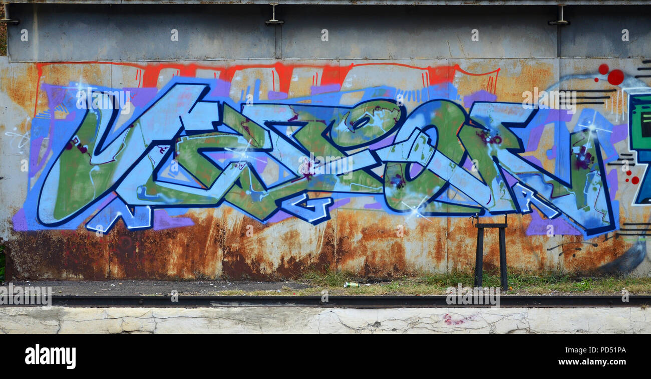 Some elements of a large and composite graffiti pattern on the wall ...