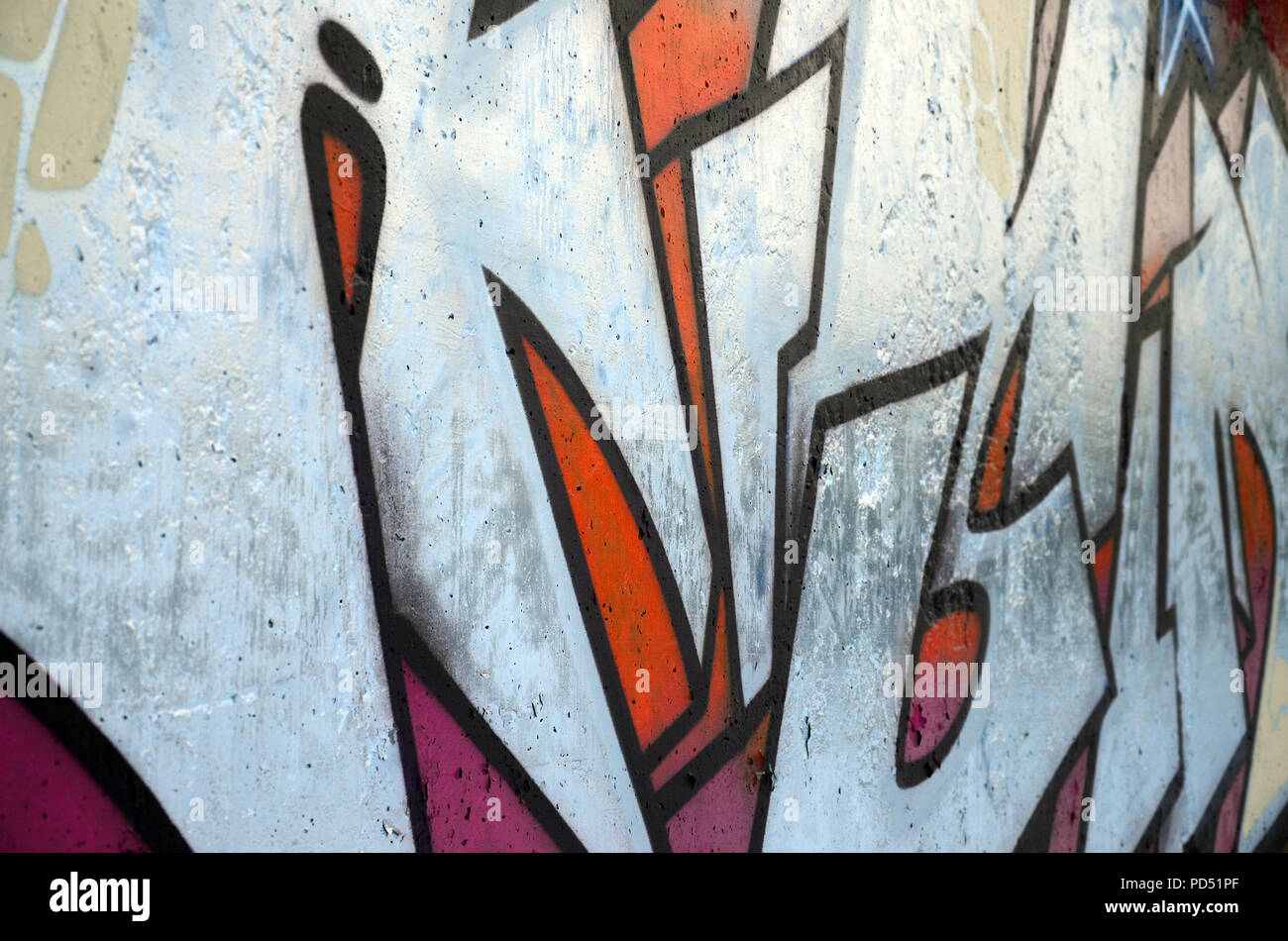 The old wall, painted in color graffiti drawing red aerosol paints ...