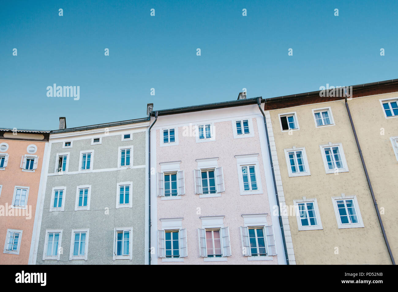Multicolored houses with many windows against the blue sky Stock Photo ...