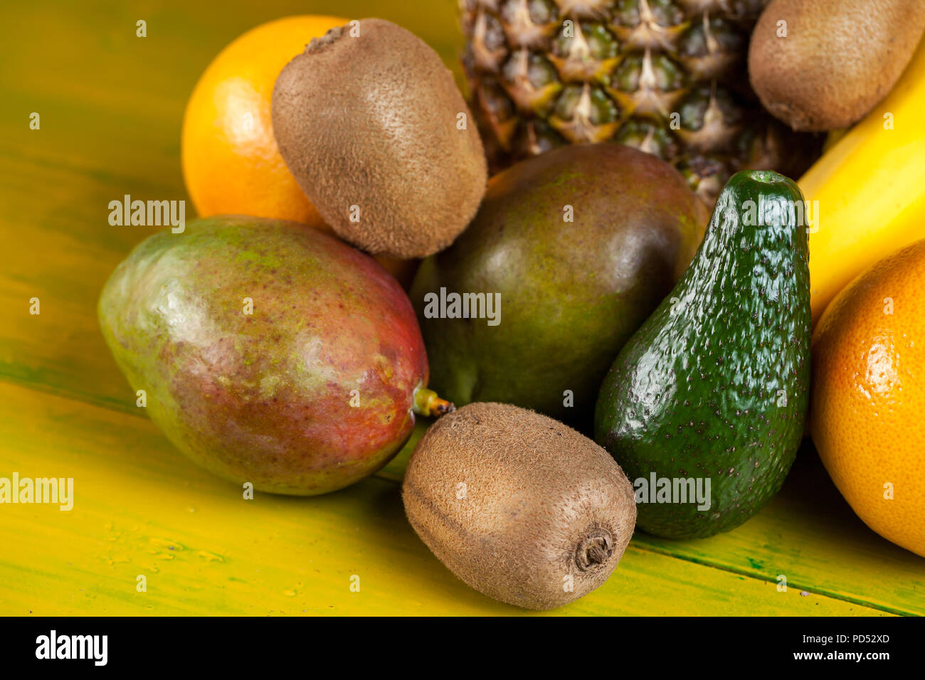 Tropical fruit on yellow wooden background, fresh food Stock Photo - Alamy