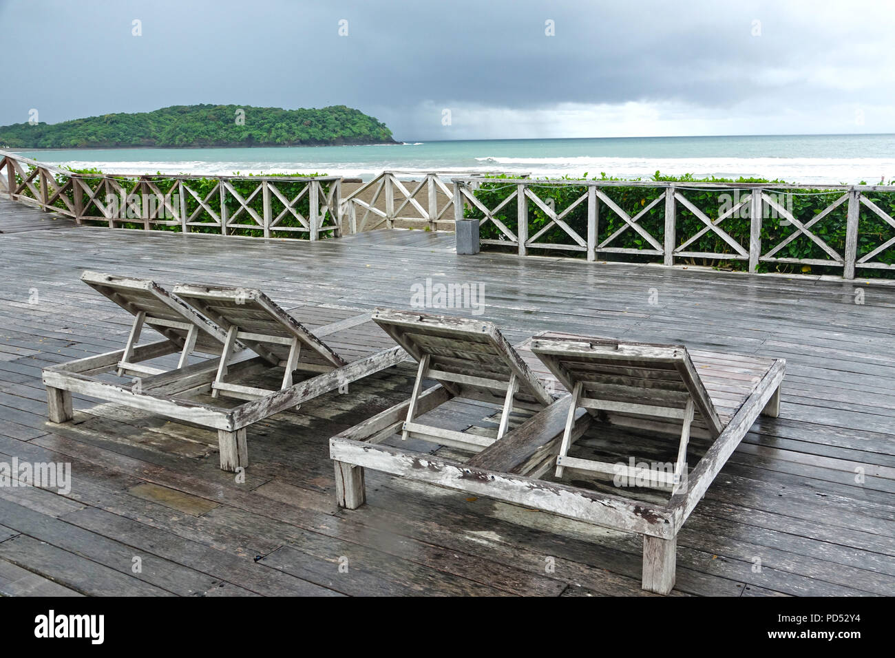 Wood deck with chairs in a tropical beach looking towards the Pacific ...