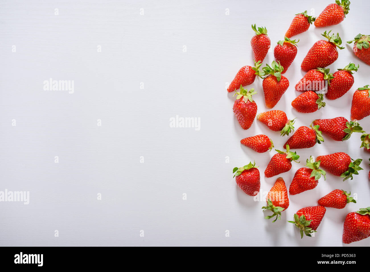 strawberry fruits on the right side on wooden background with copy ...