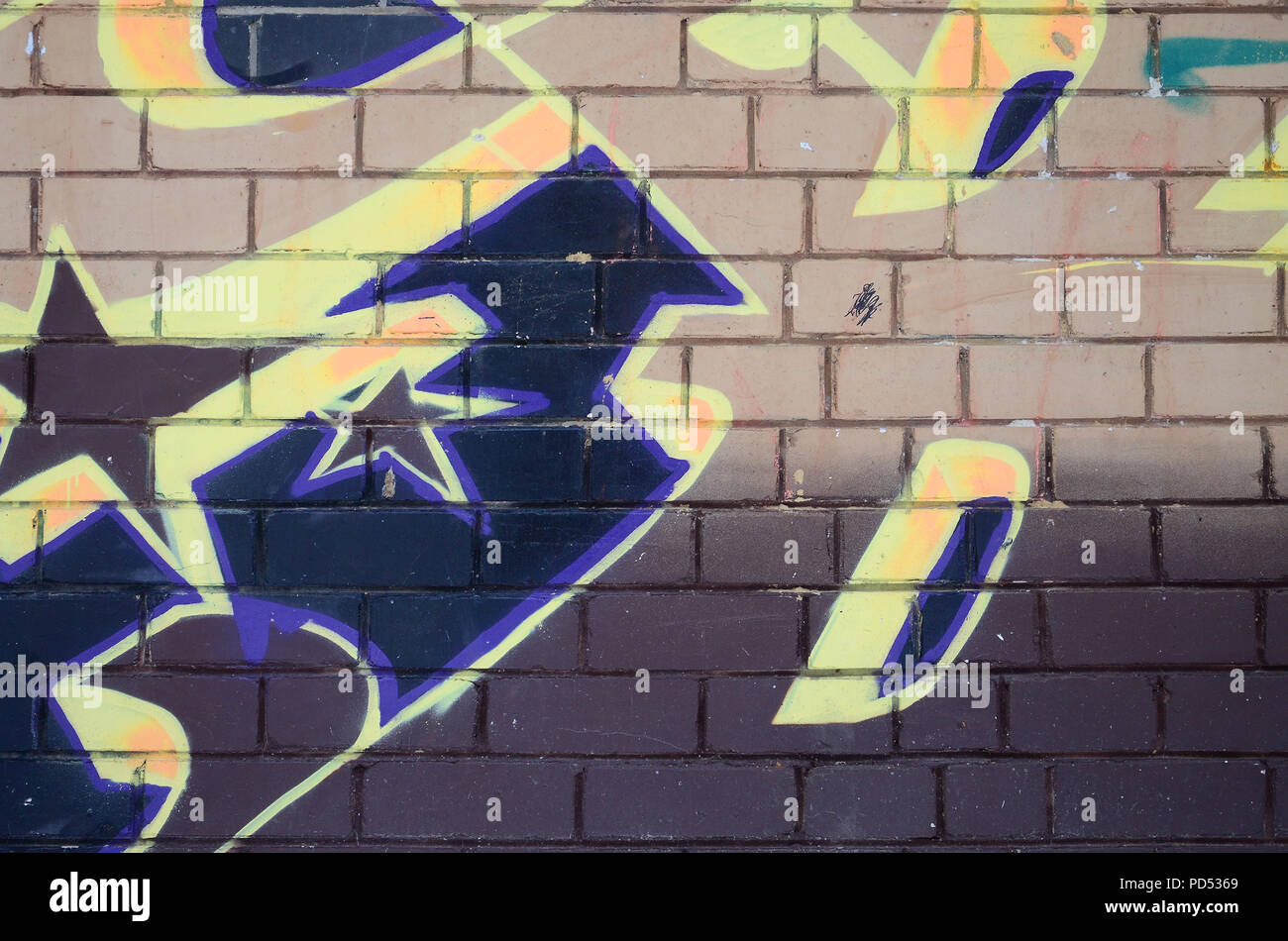 The old wall, painted in color graffiti drawing red aerosol paints ...