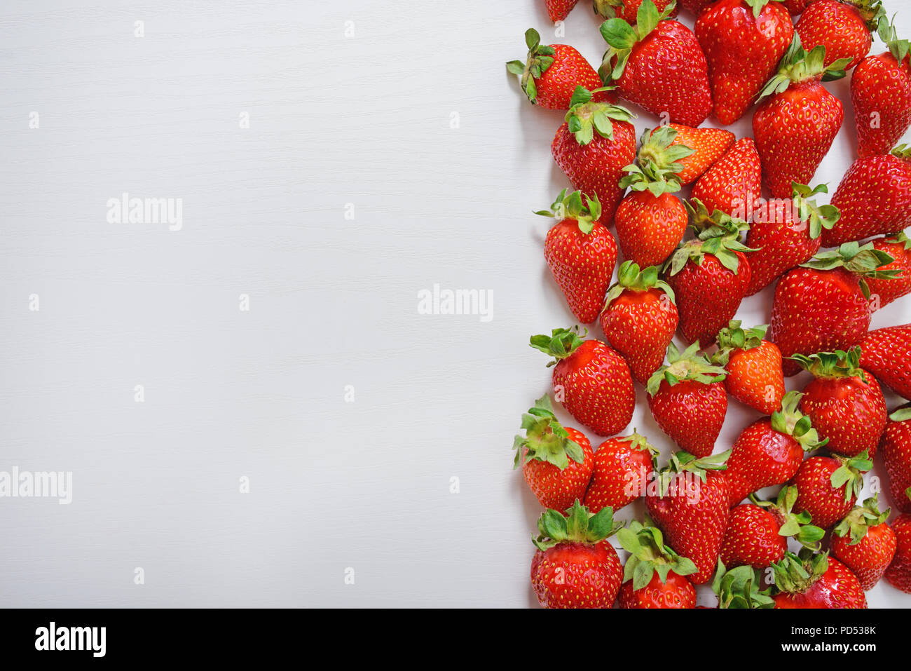 strawberry fruits on the right side on wooden background with copy ...