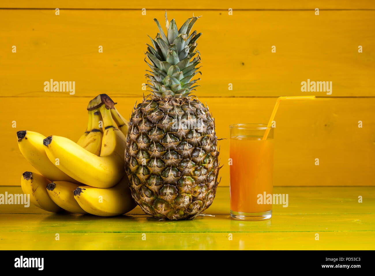 Tropical fruit on yellow wooden background, fresh food Stock Photo - Alamy