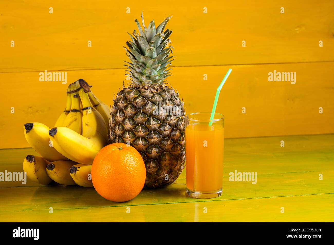 Tropical fruit on yellow wooden background, fresh food Stock Photo - Alamy