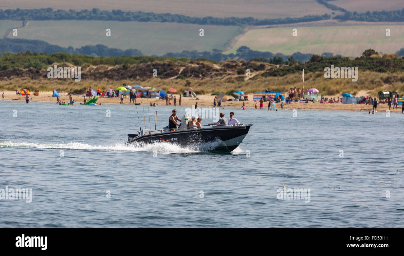 People out enjoying the very hot weather, riding the waves, boating and ...