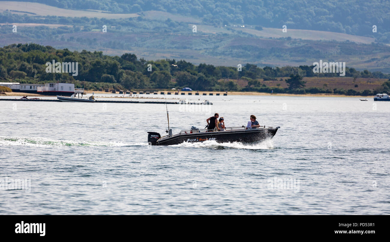 People out enjoying the very hot weather, riding the waves, boating and ...