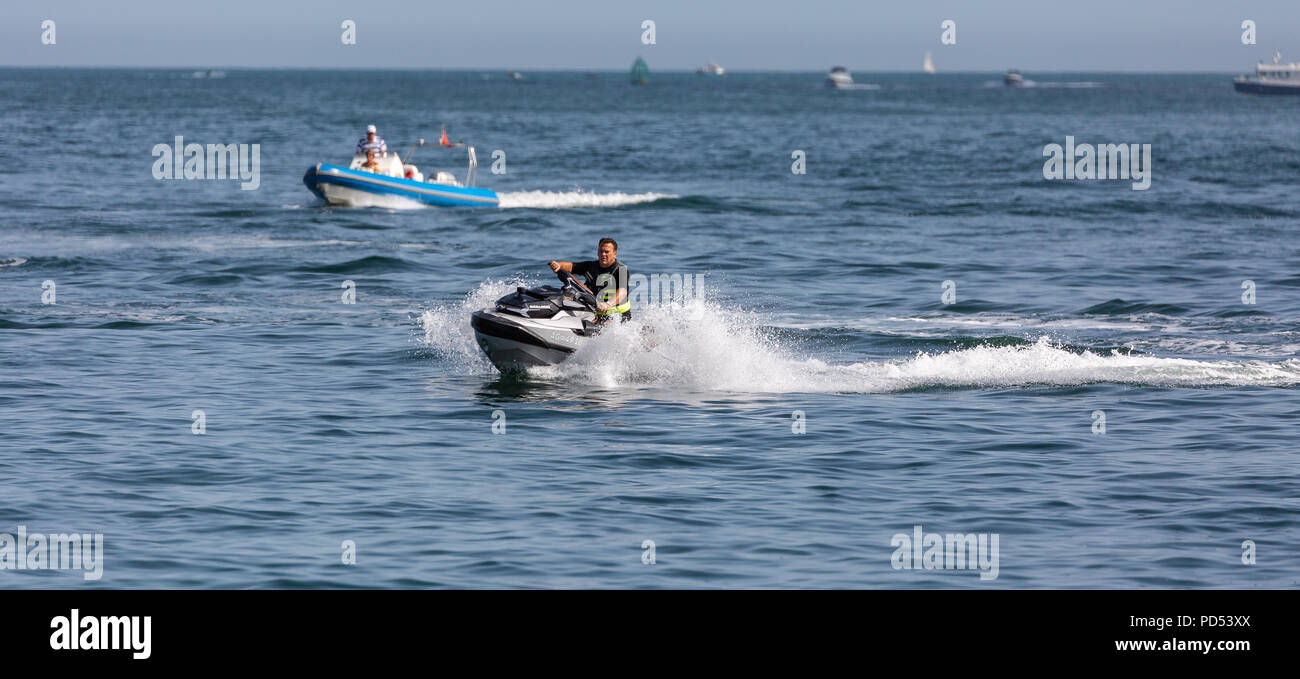 People out enjoying the very hot weather, riding the waves, boating and ...