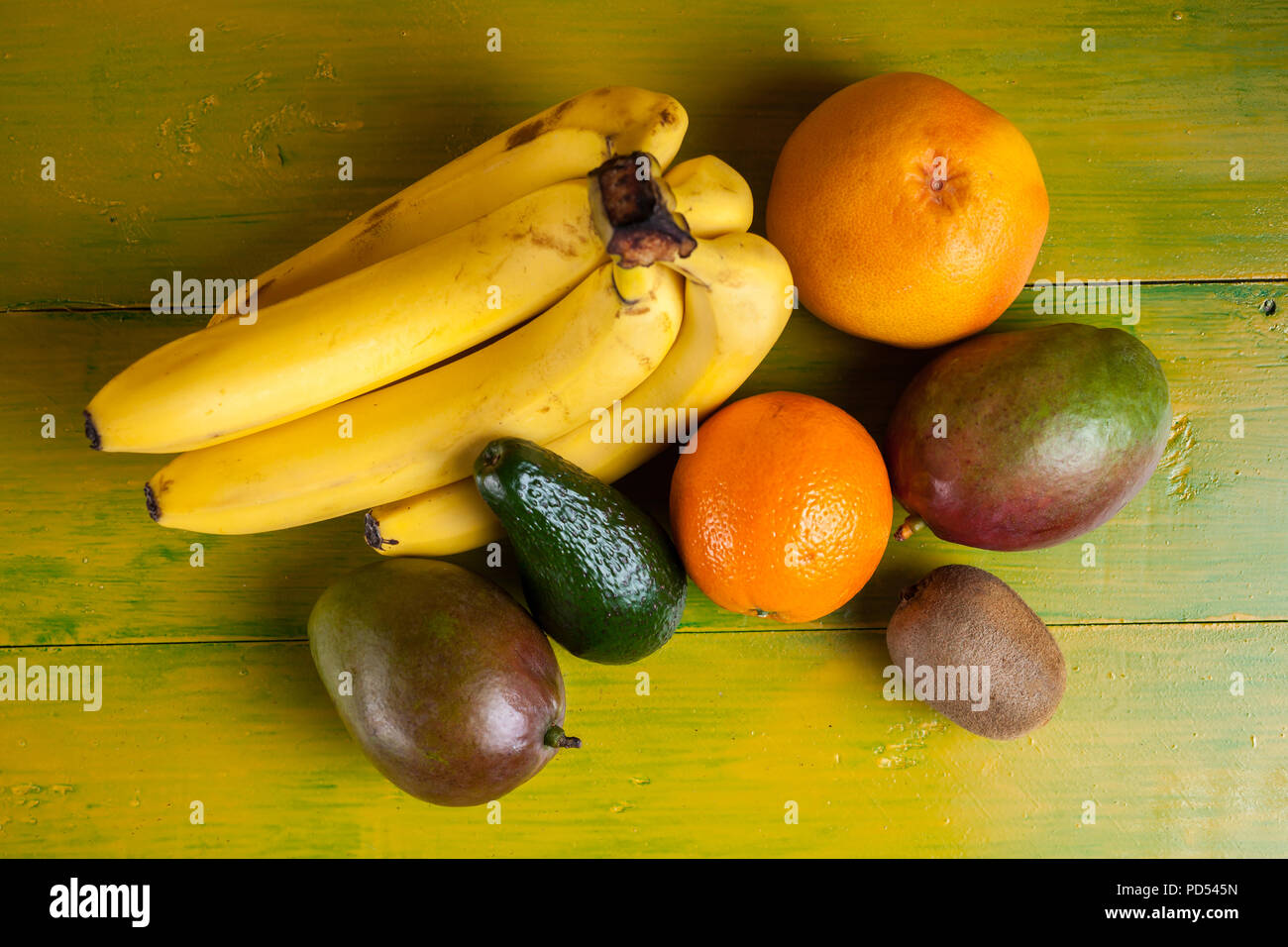 Tropical fruit on yellow wooden background, fresh food Stock Photo - Alamy