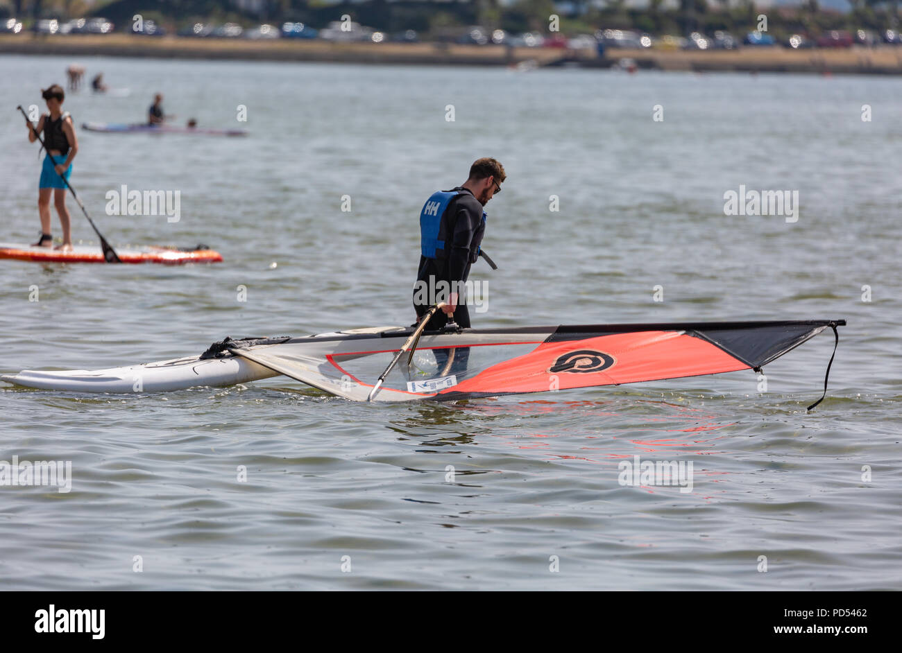 People out enjoying the very hot weather, riding the waves, boating and ...