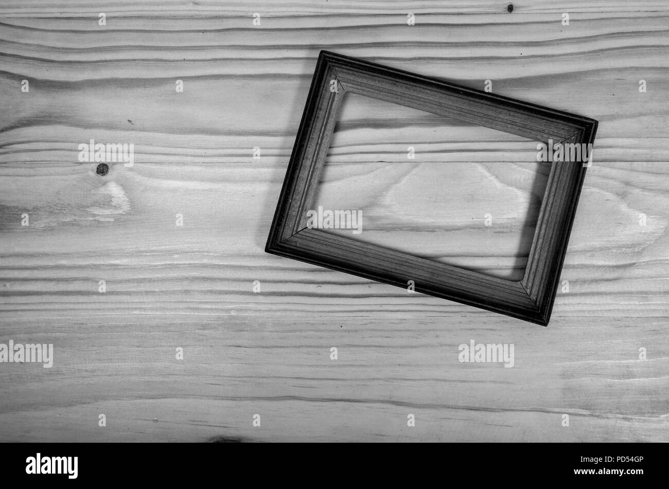 Photo frame on a wooden table in black and white Stock Photo - Alamy