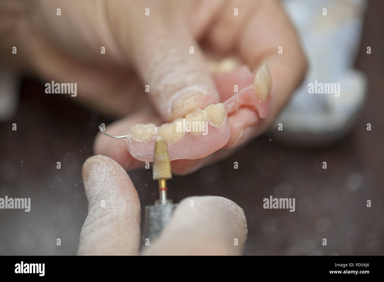 Dental technician make denture prothesis in dental laboratory, close up ...