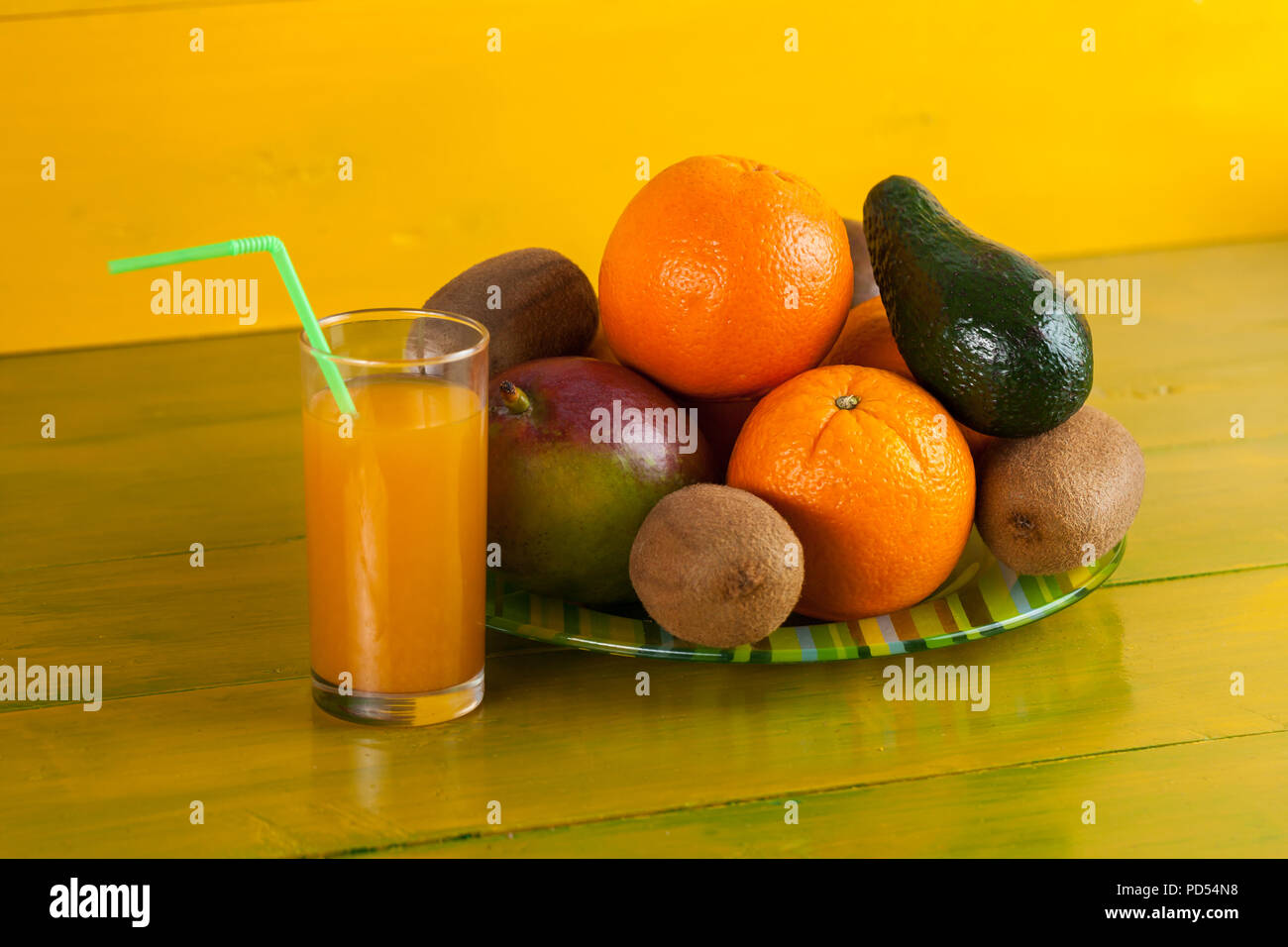 Tropical fruit on yellow wooden background, fresh food Stock Photo - Alamy