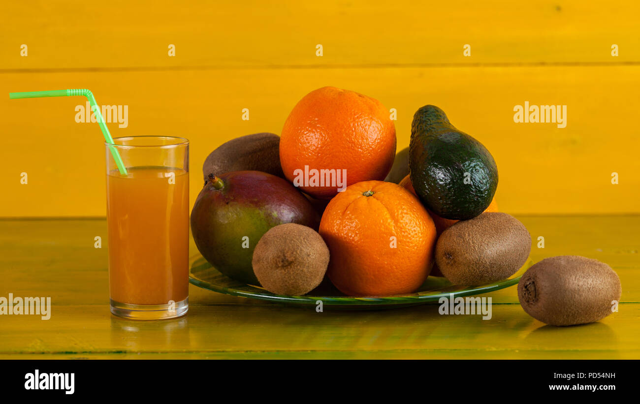 Tropical fruit on yellow wooden background, fresh food Stock Photo - Alamy