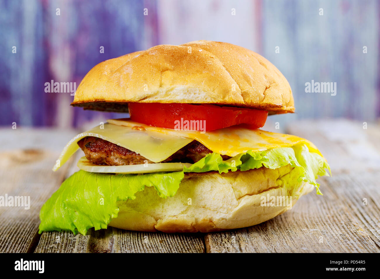 Home Made Burgers with salad cheese and onion, served on rustic wooden ...