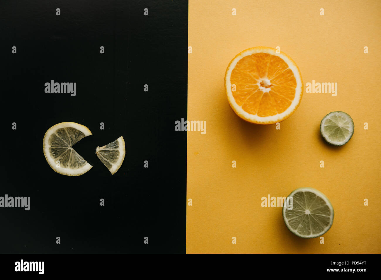Citrus on a black and yellow background. Many slices of lemon, orange ...