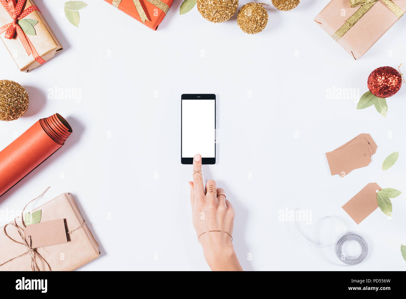 Women's hand using mobile phone among holiday composition of shiny ...