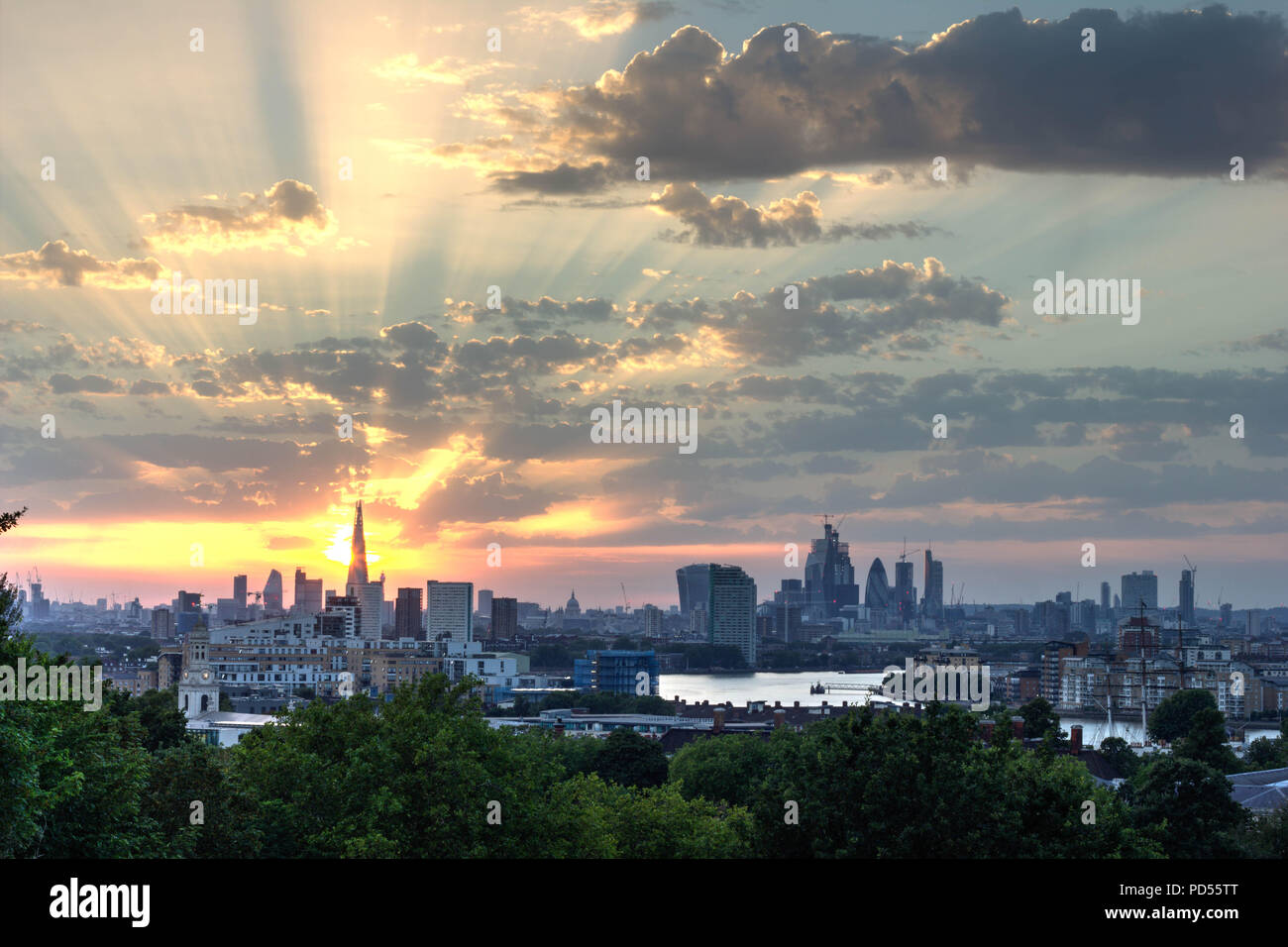 view from south London of Sunset rays beam through cloud over the Shard ...