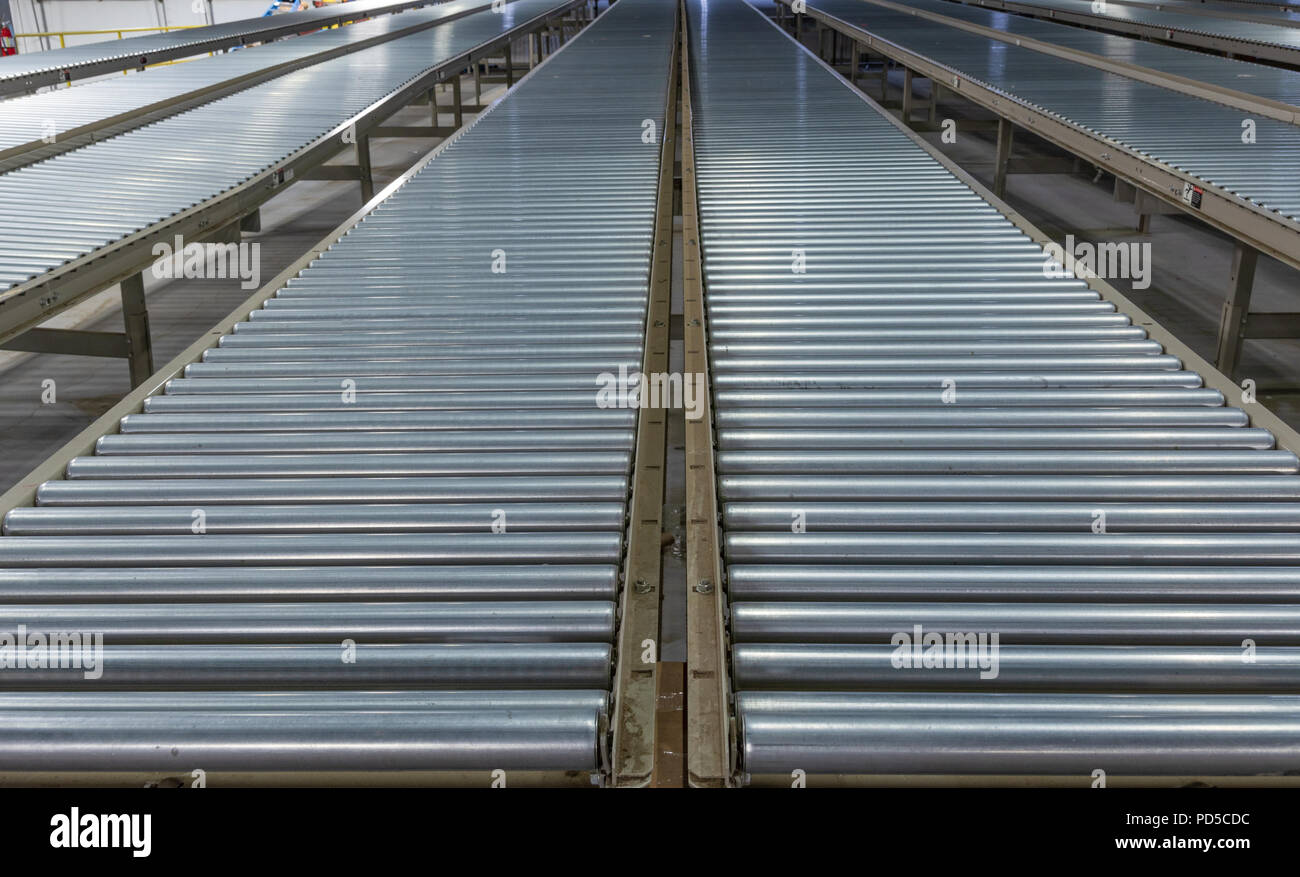 Low, converging perspective of industrial steel roller conveyors Stock ...