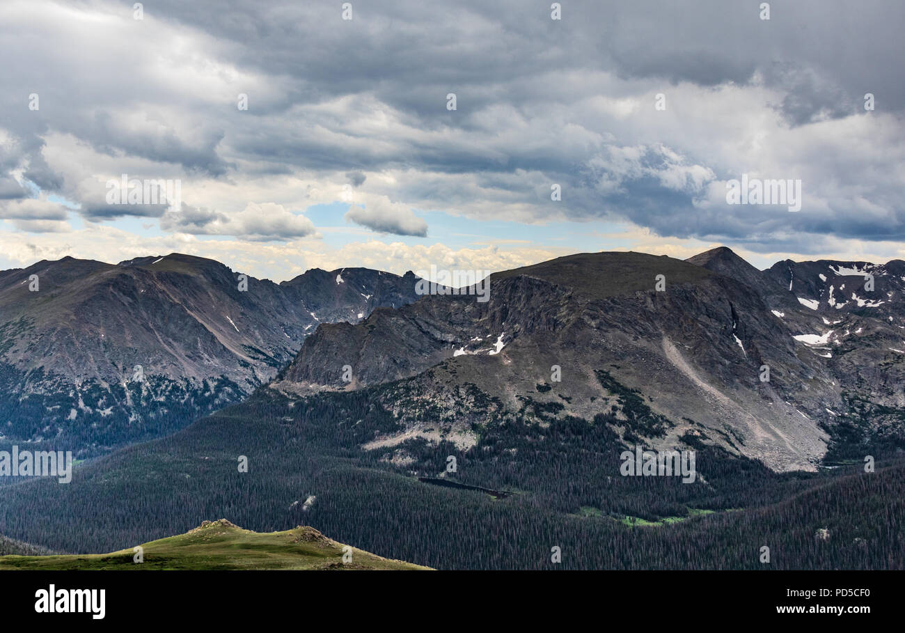 Clear, blue-gray Colorado Rocky Mountains, with dark evergreen forest ...