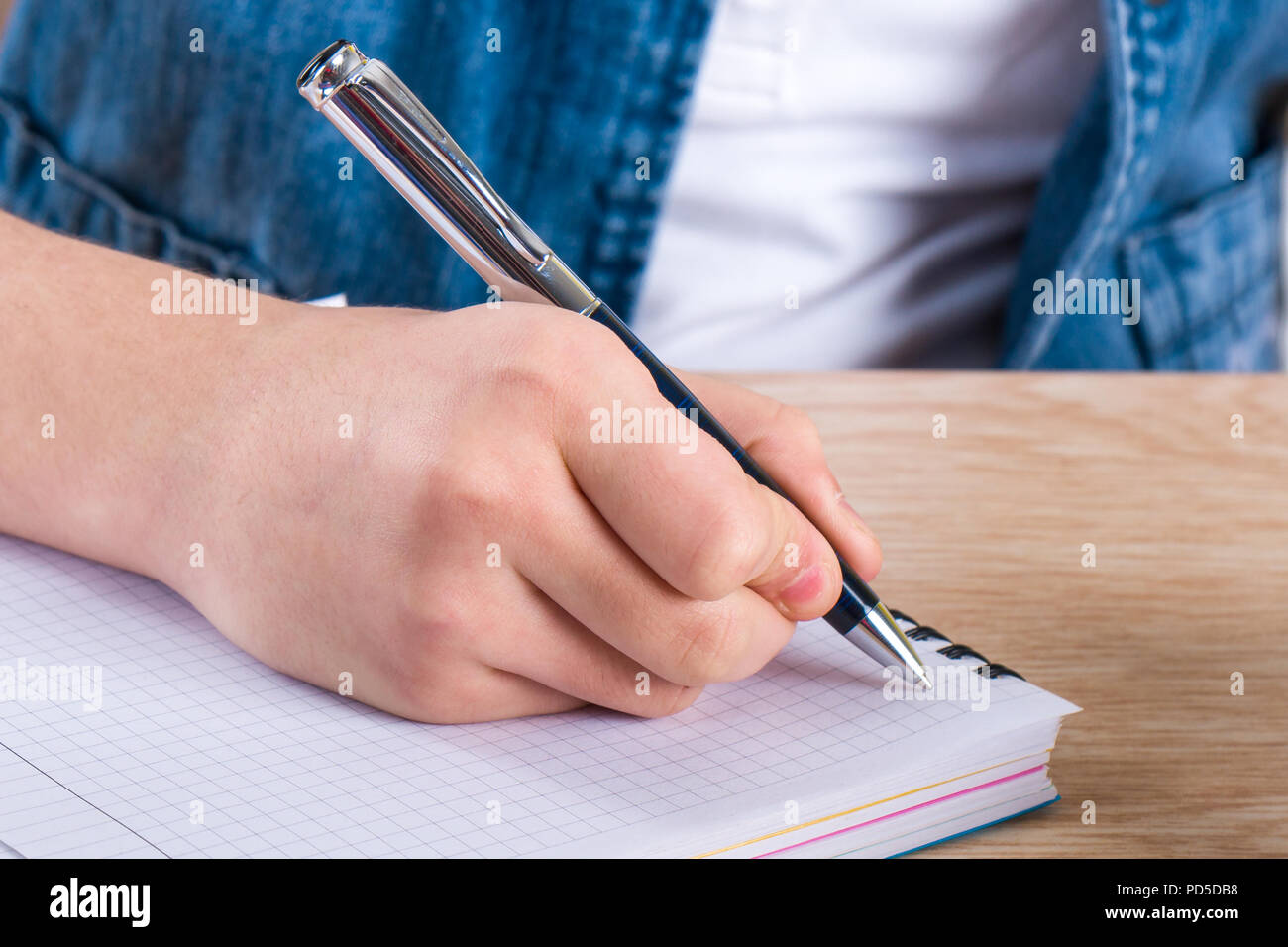 Child's hand holding pen. The child writing letters in a notebook Stock ...