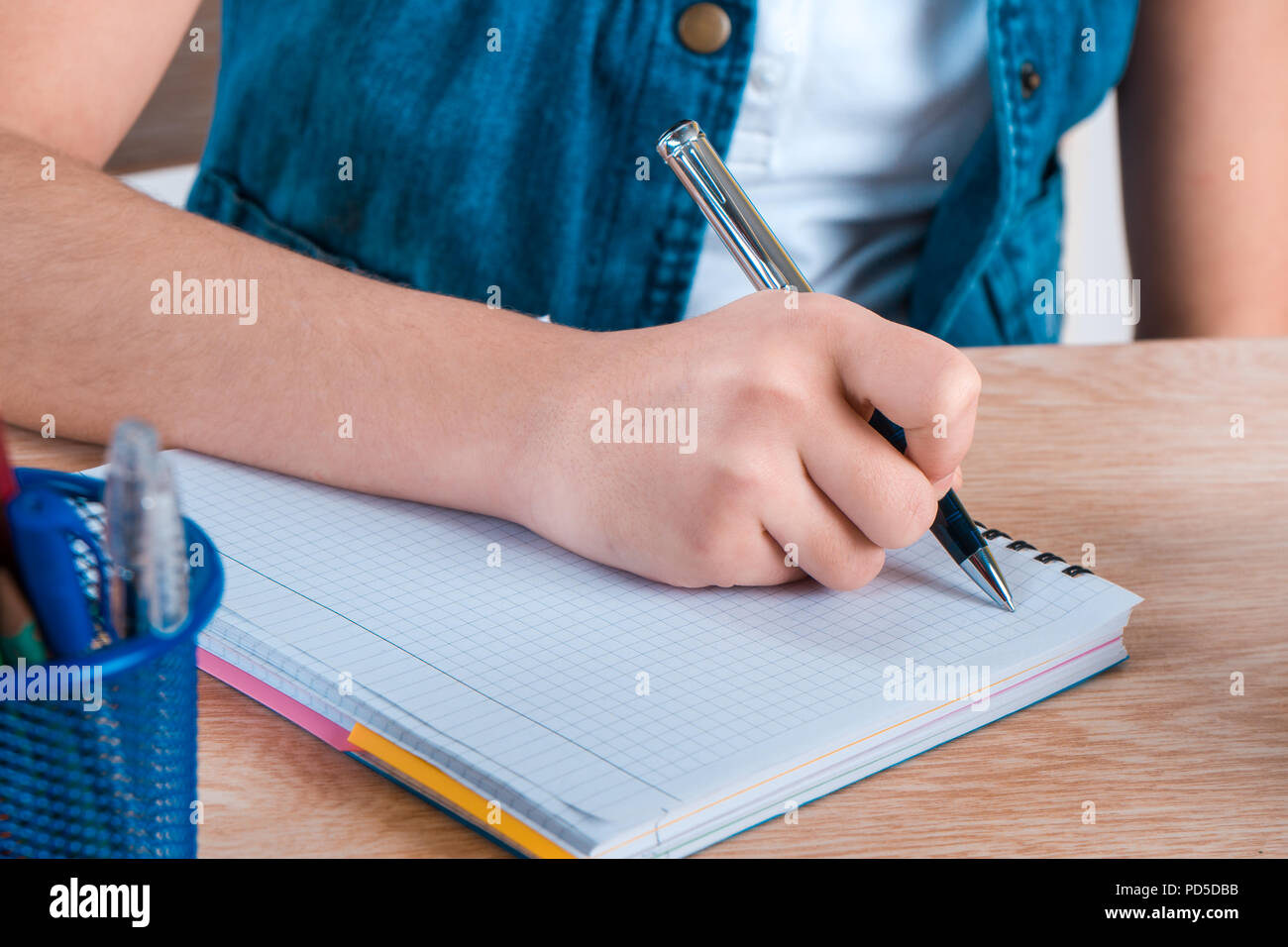 Child's hand holding pen. The child writing letters in a notebook Stock ...