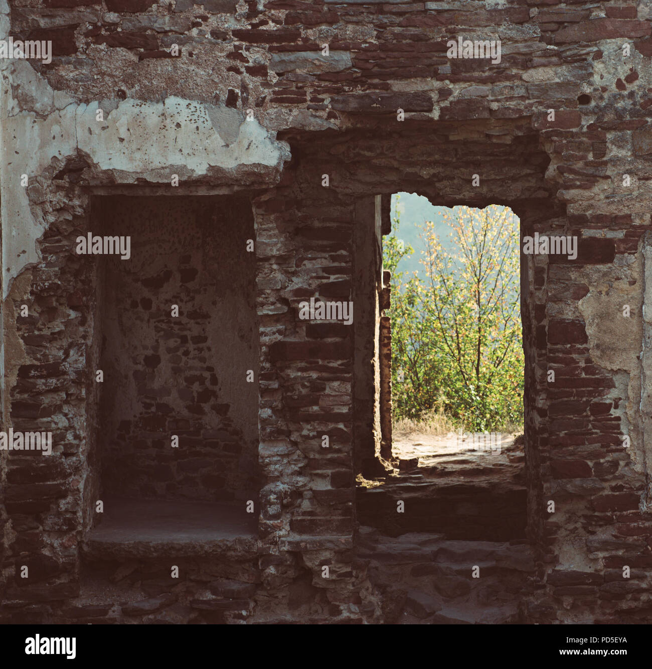 Old weathered ruined wall with breach from door, cracks and scratches ...