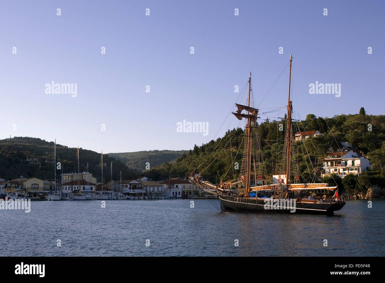 The harbour at Lakka, Paxos, Greece in early morning, with the topsail ...