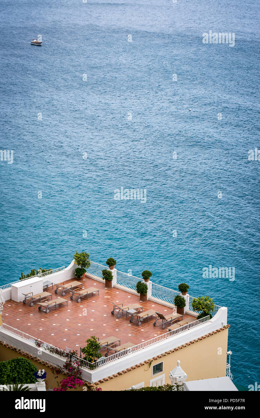 Positano, Building next to sea with Deckchairs on the roof, Amalfi ...