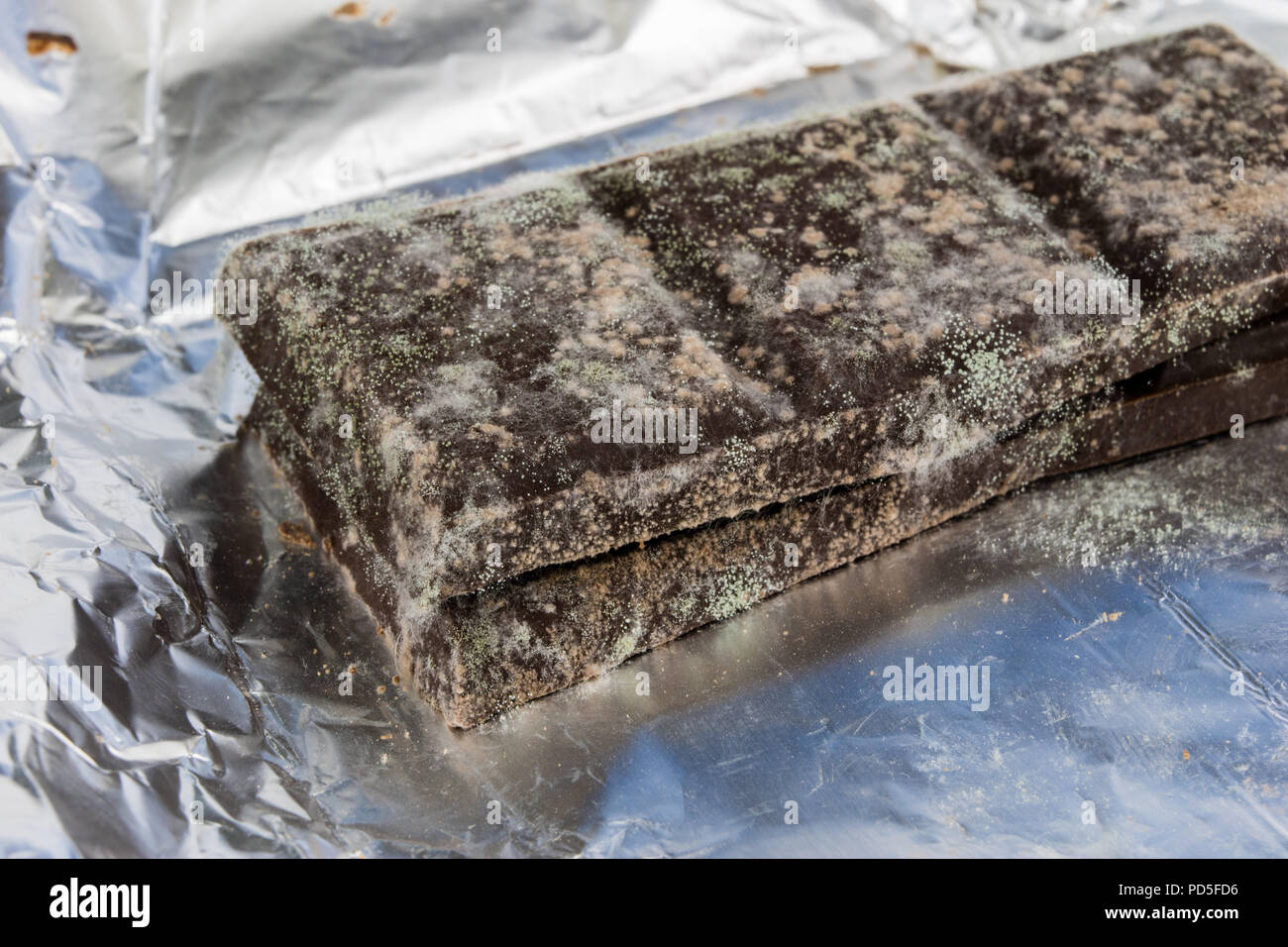 Moldy chocolate in the original packaging. Out-dated food products used ...