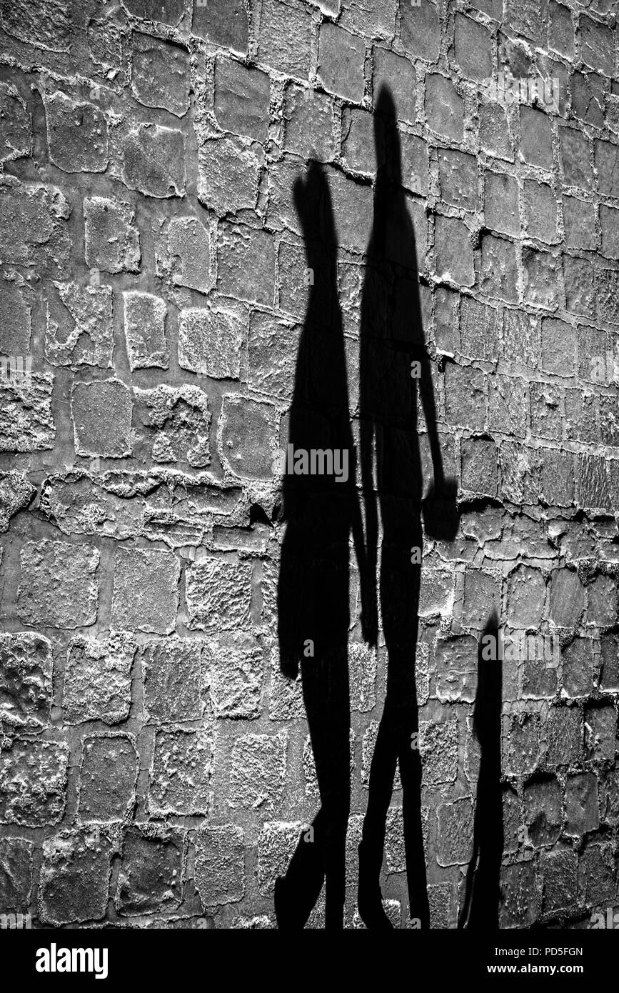 People shadows on stone wall, San Miguel de Allende, a colonial-era ...