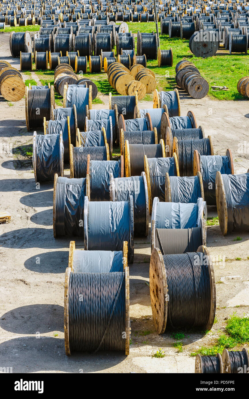electricity cable on wooden spools on the floor Stock Photo - Alamy