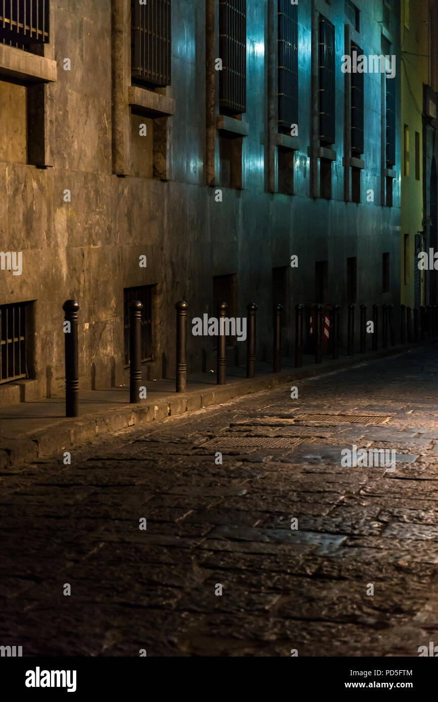 Street at night with light reflections on a building, Naples, Italy ...