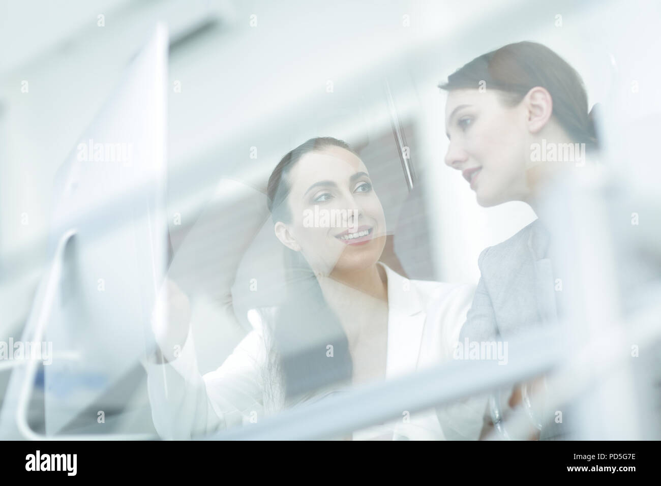 behind the glass.business team sitting at Desk Stock Photo - Alamy