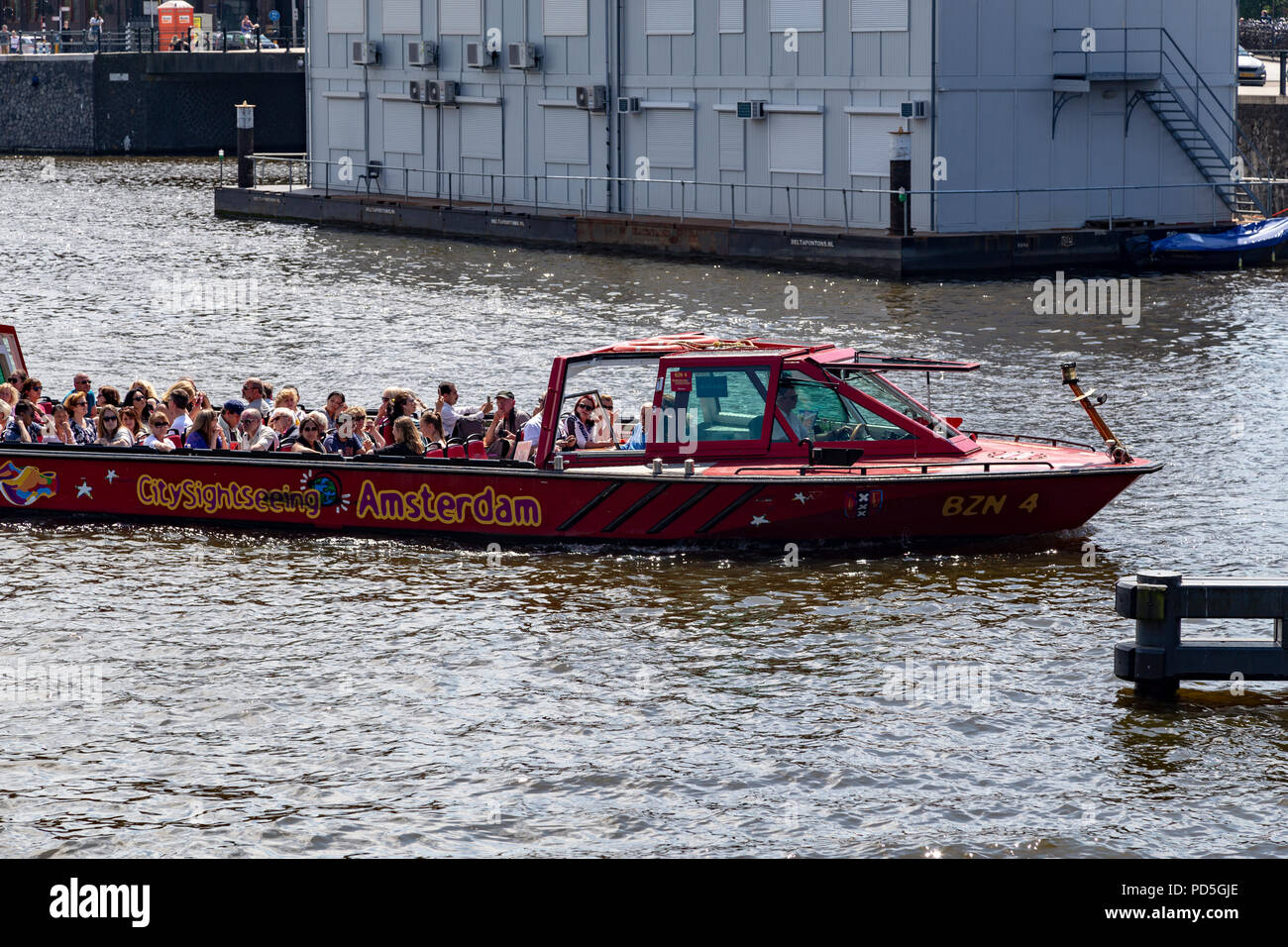 Tourists boating on the Amsterdam canals, Netherlands Stock Photo - Alamy