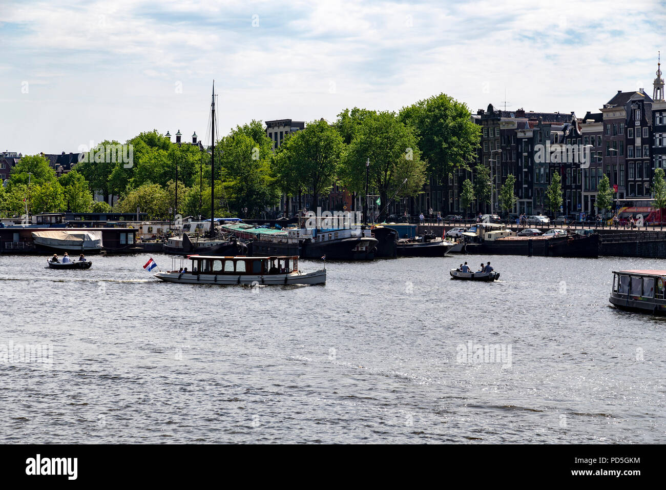 Tourists boating on the Amsterdam canals, Netherlands Stock Photo - Alamy