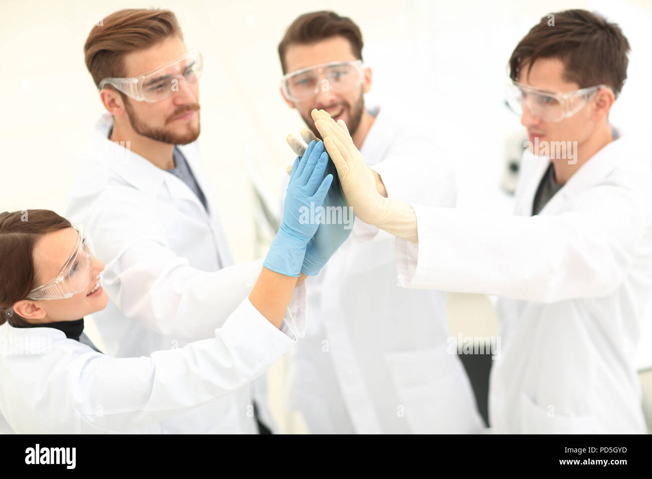 scientists giving each other a high five Stock Photo - Alamy