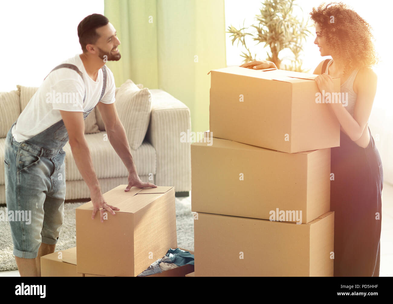 Happy and young couple looking at boxes Stock Photo - Alamy