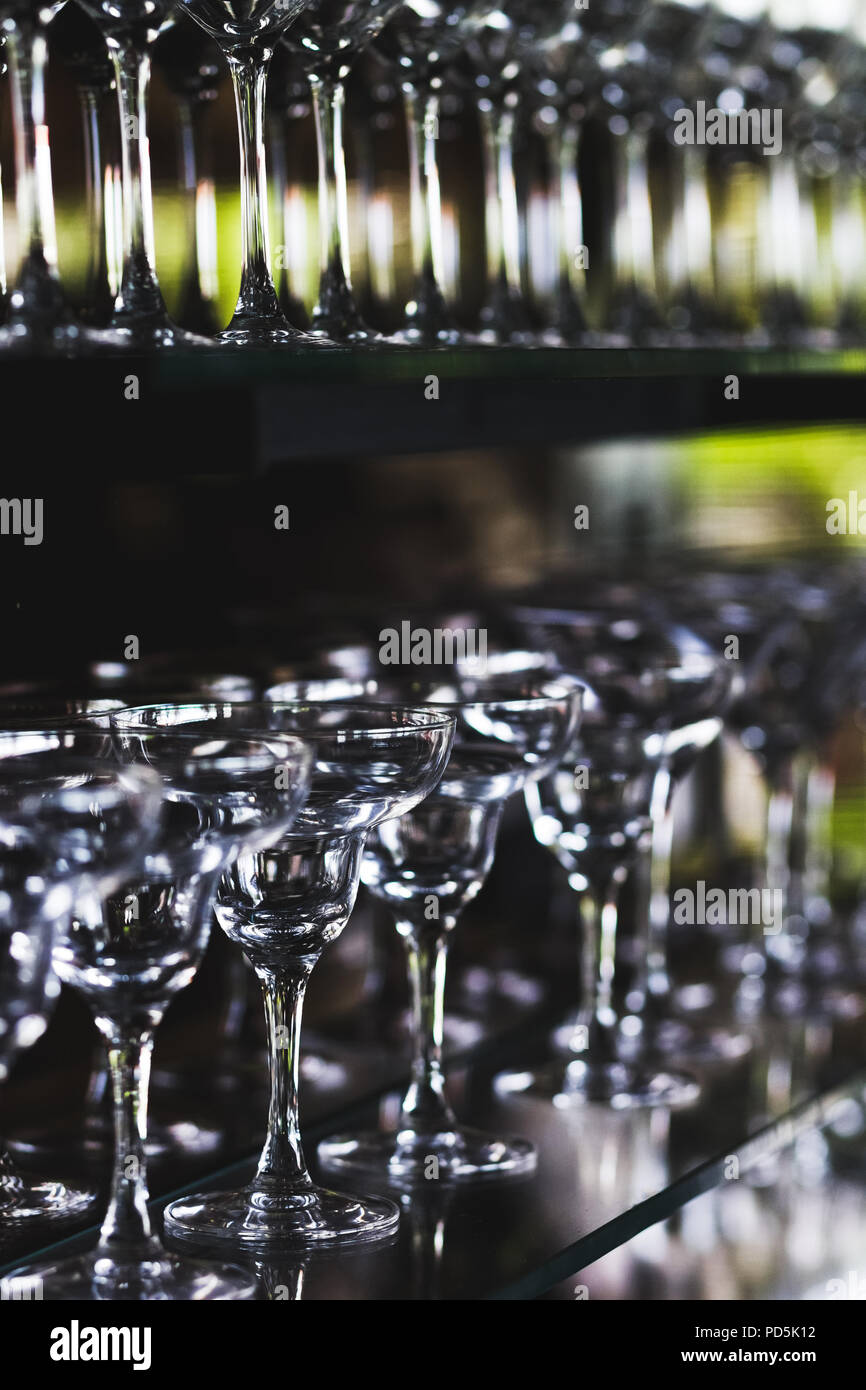 Set of glasses in the bar on a dark background Stock Photo - Alamy