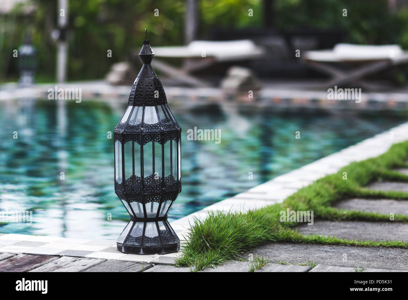 Vintage metal lantern near swimming pool Stock Photo - Alamy