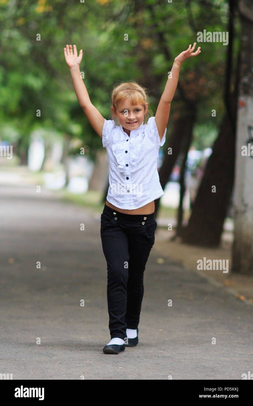 one happy schoolgirl pupil having fun outdoors Stock Photo - Alamy
