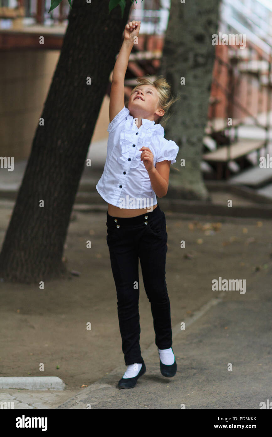 one happy schoolgirl pupil having fun outdoors Stock Photo - Alamy